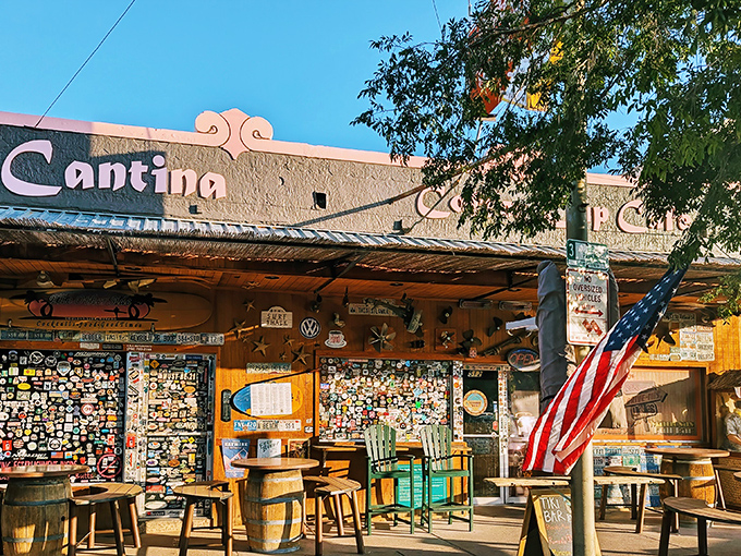 The sticker-covered facade of The Coffee Cup screams "characters welcome!" American flags flutter beside barrel tables where stories are exchanged over coffee.