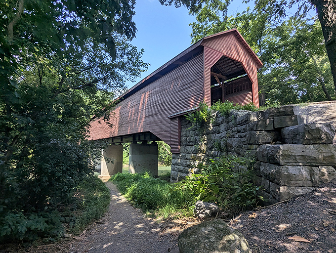 Mother Nature's perfect frame for Meem's Bottom Covered Bridge, where the rustic red structure creates a striking contrast against the flowing Shenandoah River below.