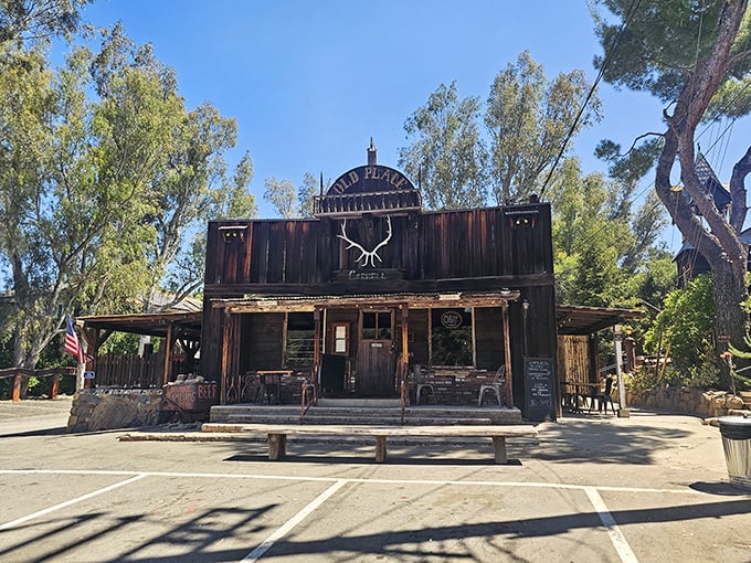 Like stepping onto a Western movie set, The Old Place's weathered wooden facade stands defiantly against time, antlers proudly announcing your arrival.