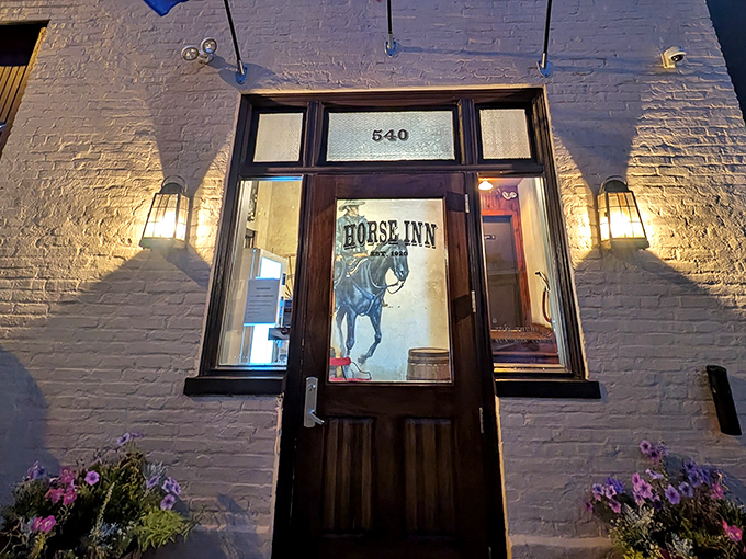 The unassuming entrance to Horse Inn beckons like a secret handshake, its white brick facade and wooden door promising culinary adventures for those in the know.