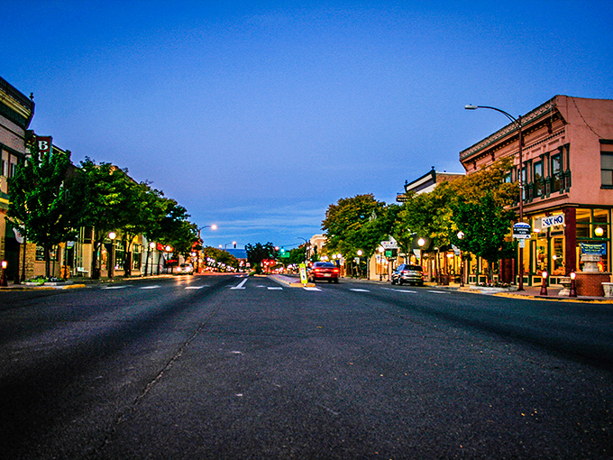 Main Street at dusk captures the essence of small-town charm without small-town limitations. The historic buildings house modern amenities with old-fashioned pricing.