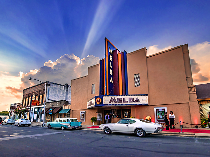The Melba Theater stands like a time capsule on Batesville's Main Street, its neon glow promising affordable entertainment and community connection.