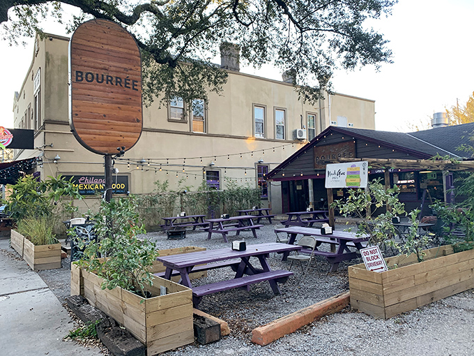 Bourr&eacute;e's inviting courtyard beckons with picnic tables, string lights, and lush planters&mdash;the perfect setting for chicken feasting in New Orleans.