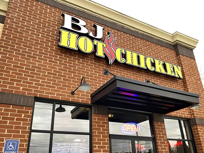 The brick facade and bold signage of BJ Hot Chicken stands as Nashville's modern temple to the city's most famous culinary contribution. Fire-kissed letters promise heat that delivers.