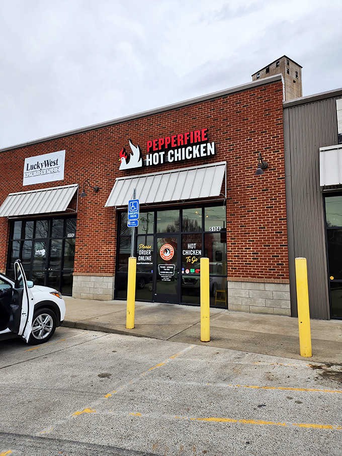 The brick facade of Pepperfire beckons like a spicy siren, its bold red sign promising a Nashville heat experience that'll warm your soul—and everything else.