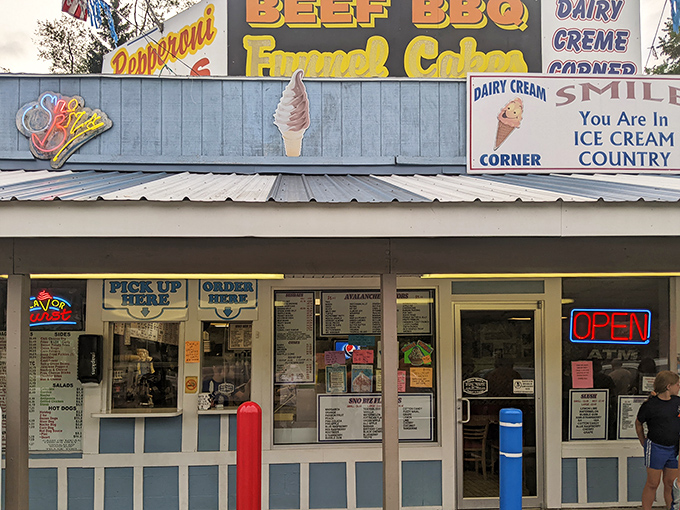 The blue-striped haven of happiness announces itself with colorful signs and pennant flags&mdash;summer incarnate in architectural form.