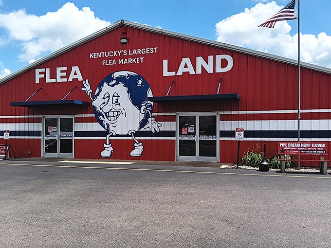 The iconic red exterior of Flea Land stands like a beacon for bargain hunters, complete with its cheerful globe mascot welcoming treasure seekers.