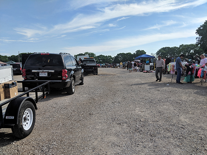 Early birds catch the deals at South Drive-In's flea market, where treasure hunters navigate rows of vendors under Columbus's big blue sky.