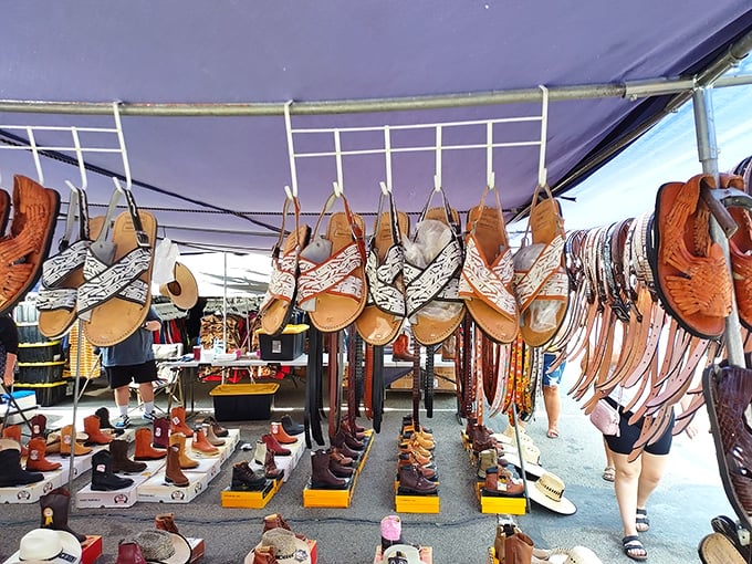 Handcrafted leather sandals and boots hang like edible ornaments in this artisan's display. Cowboy chic meets comfort in a festival of footwear that would make any shoe lover weak at the knees.