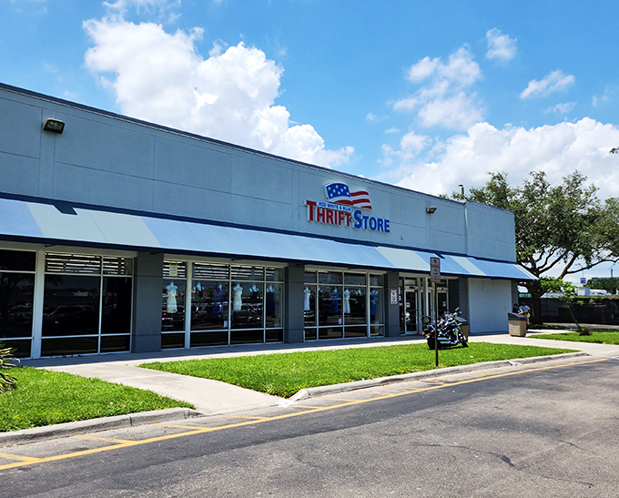 The patriotic blue awning beckons like a siren song to bargain hunters. This unassuming exterior hides a treasure trove that would make Indiana Jones reconsider his career path.