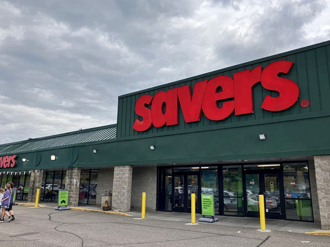 The iconic red Savers sign glows like a beacon for treasure hunters, promising adventures in secondhand splendor just beyond those automatic doors.