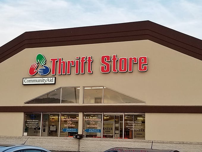 The welcoming facade of CommunityAid beckons treasure hunters with its colorful logo &ndash; like a retail Narnia hiding behind ordinary doors. Bargain paradise awaits!