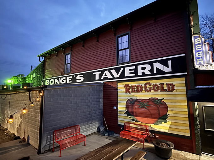 The burgundy-colored exterior of Bonge's Tavern stands as a beacon of culinary promise in the Indiana countryside, complete with string lights that twinkle like rural stars.