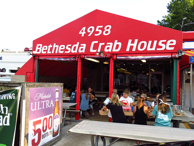 The bright coral-red awning of Bethesda Crab House stands out like a beacon to seafood lovers. No pretension here, just the promise of Maryland's finest crustaceans.