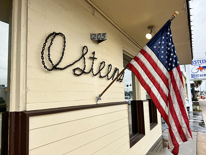 The unassuming exterior of O'Steen's, where that American flag isn't just patriotic decor&mdash;it's waving you in for seafood that'll make you salute.