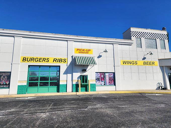 The white exterior boldly announces its priorities: BURGERS, RIBS, WINGS, BEER. No false advertising here&mdash;just a promise of delicious things to come.