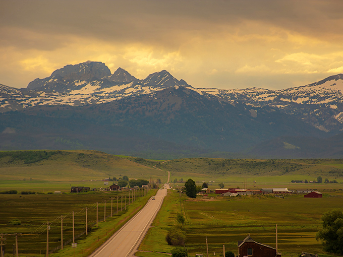 The road less traveled? Not with views like these! Idaho's Teton Scenic Byway stretches toward mountains that look painted onto the horizon.
