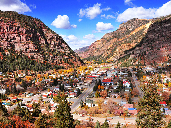 Ouray nestles into its box canyon like nature's perfect snow globe, a tiny civilization surrounded by the San Juan Mountains' majestic embrace.