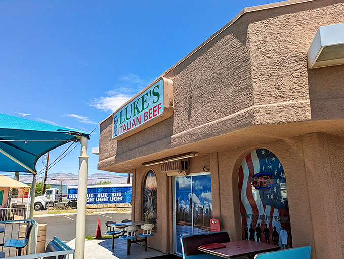 The unassuming tan exterior of Luke's Italian Beef stands like a culinary oasis in Tucson, its blue awning offering shade and promise of Chicago-style delights within.