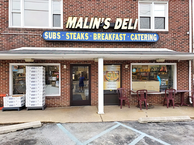 The iconic yellow sign of Malin's Deli stands out against the brick facade like a beacon of sandwich salvation for hungry Delawareans.