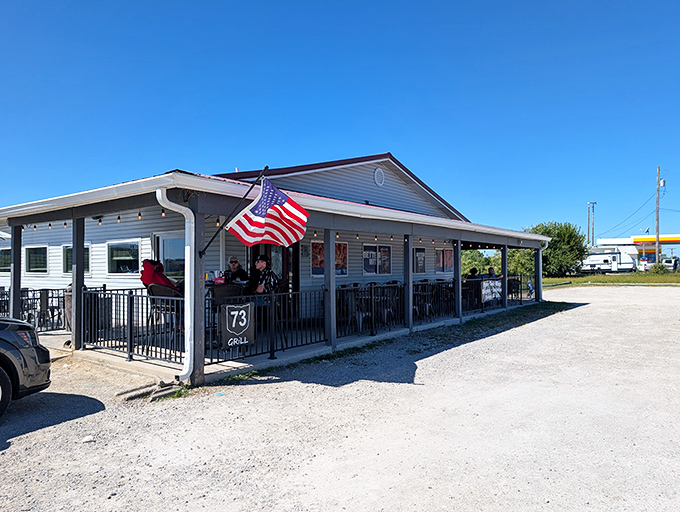 The American flag waves proudly outside 73 Grill, a humble roadside beacon promising delicious comfort in Wilmington. Taco Tuesday sign optional, satisfaction guaranteed.