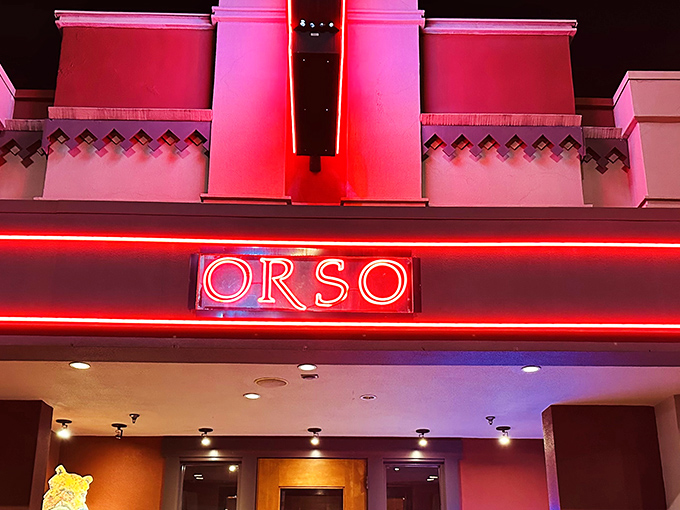 Orso's neon glow beckons like a lighthouse for hungry souls navigating downtown Anchorage. The warm red signage promises culinary comfort ahead.