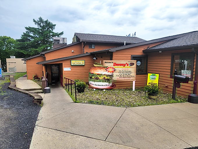 The orange exterior of Denny's Beer Barrel Pub stands as a beacon to burger pilgrims, complete with a burger sculpture that foreshadows the enormity awaiting inside.