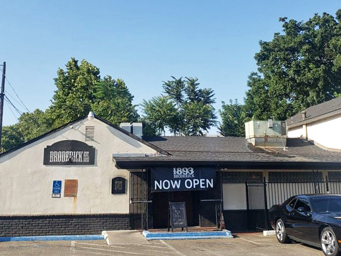 A simple white building with a bold statement: "NOW OPEN." In the restaurant world, understatement often signals confidence.