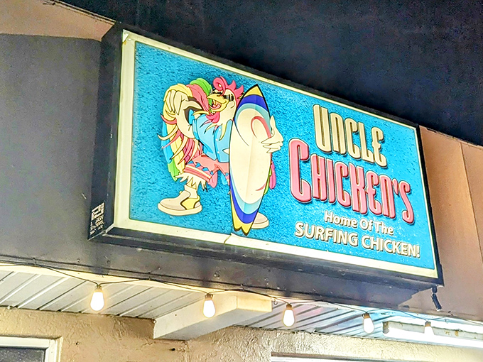 The surfing chicken beckons from this vibrant blue sign &ndash; a promise of coastal flavor that's about to change your fried chicken expectations forever.