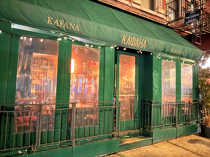As evening falls, Kafana's emerald exterior glows with warm light, transforming this East Village corner into a slice of Belgrade.