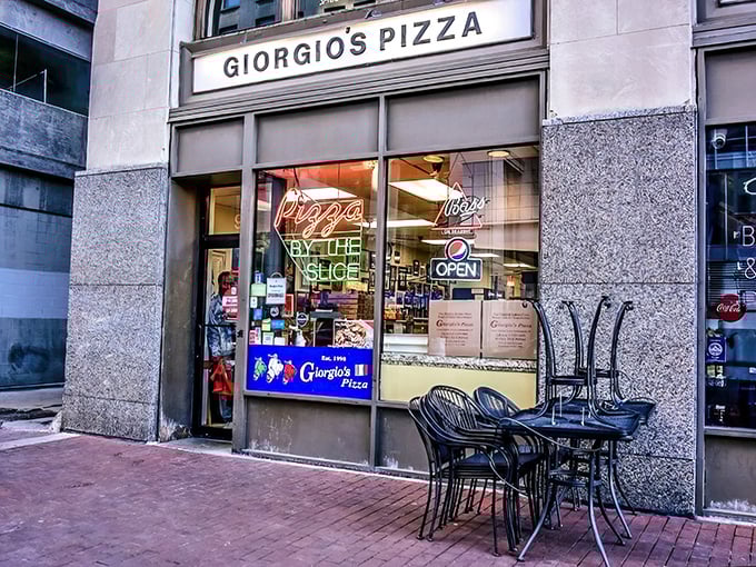 The iconic arched entrance to Giorgio's Pizza stands as a downtown Indianapolis landmark, beckoning hungry passersby with its neon promise of slice perfection.