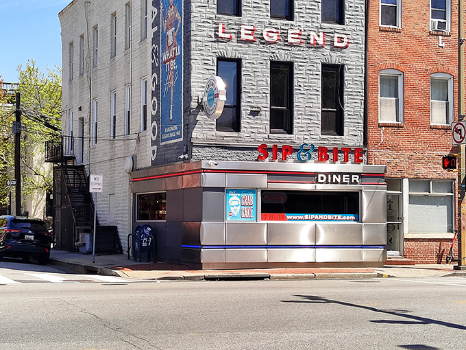 The iconic stainless steel exterior of Sip & Bite stands like a beacon of breakfast hope on Baltimore's corner, its retro signage promising delicious salvation within.