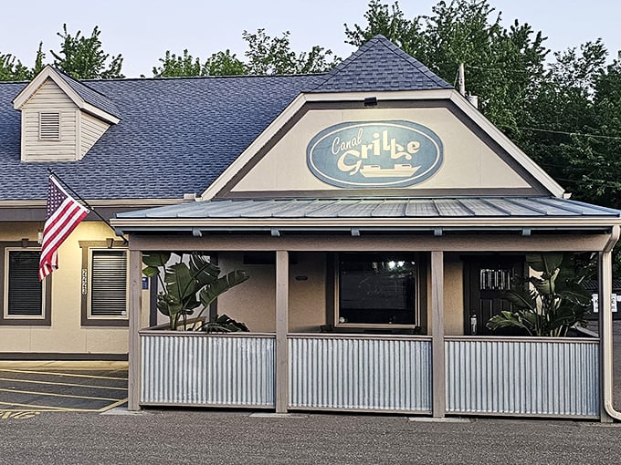 The unassuming exterior of Canal Grille proves once again that the best culinary treasures often hide behind the most modest facades. That covered porch practically whispers, "Come sit a spell."