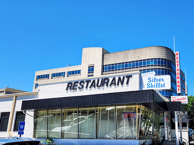 The Silver Skillet stands proudly against Atlanta's modern skyline, a time capsule of Southern cooking where breakfast dreams come true.