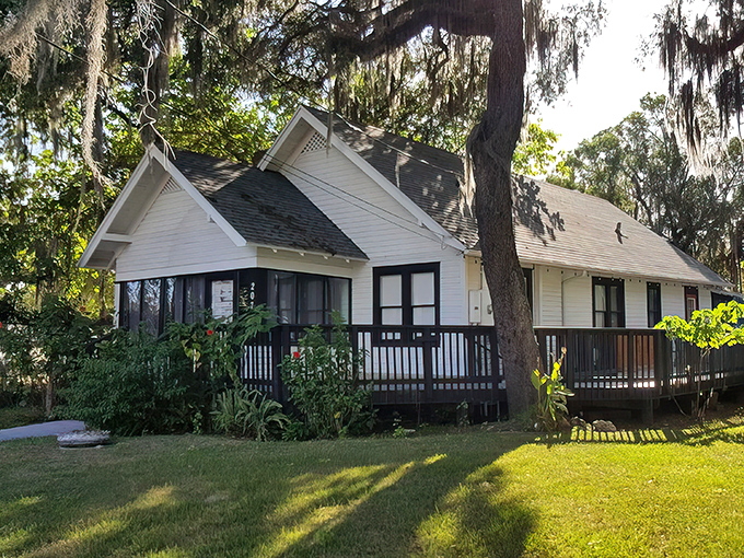 Oscar Penn's charming white cottage exterior is like finding a secret culinary clubhouse nestled among Florida's majestic Spanish moss-draped trees.