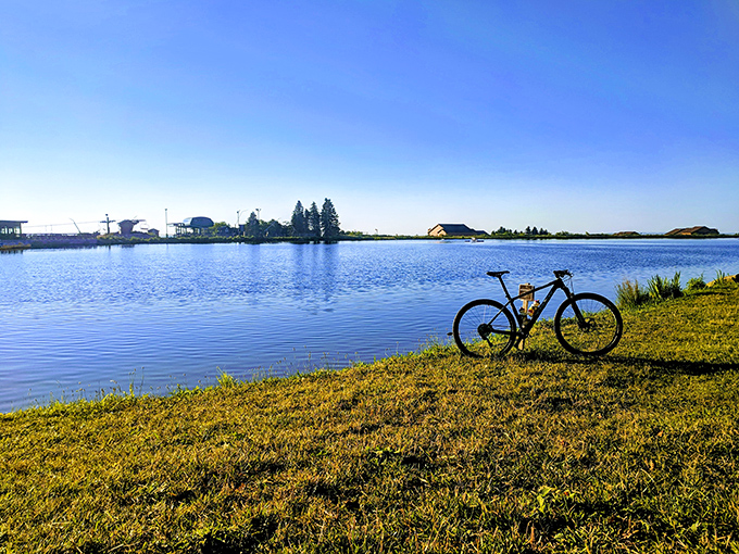 Tranquility perfected: A lone bicycle rests by the glassy waters of Laurel Ridge, nature's version of the ultimate screen saver come to life.