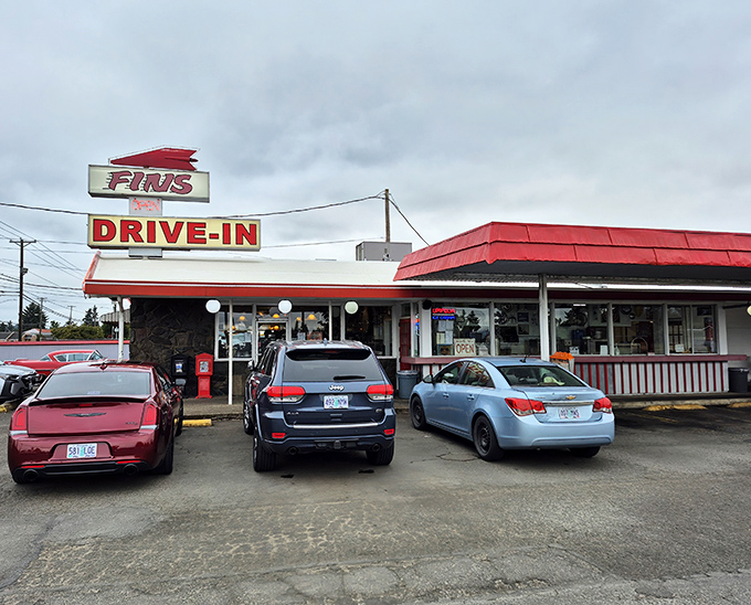 The iconic red awning of Fins Drive-In stands as a beacon of comfort food promise against Oregon's often-gray skies.