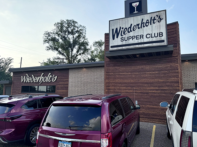 The wooden facade of Wiederholt's stands like a time capsule in Hastings, promising comfort food treasures within. That martini sign isn't just decoration&mdash;it's a beacon of hospitality.