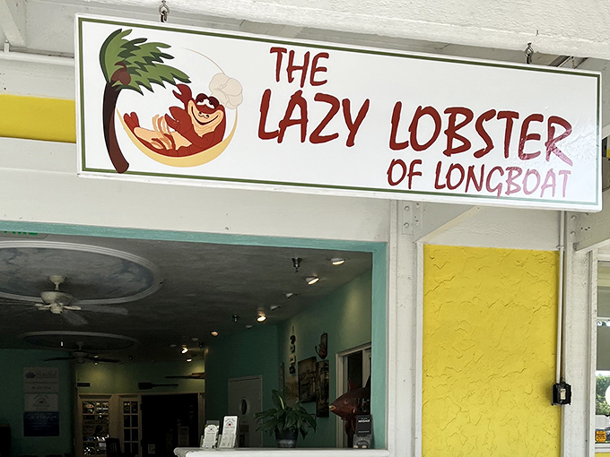 The sunshine-yellow exterior of Lazy Lobster stands out like a cheerful beacon on Longboat Key, promising seafood treasures within its tropical paradise setting.