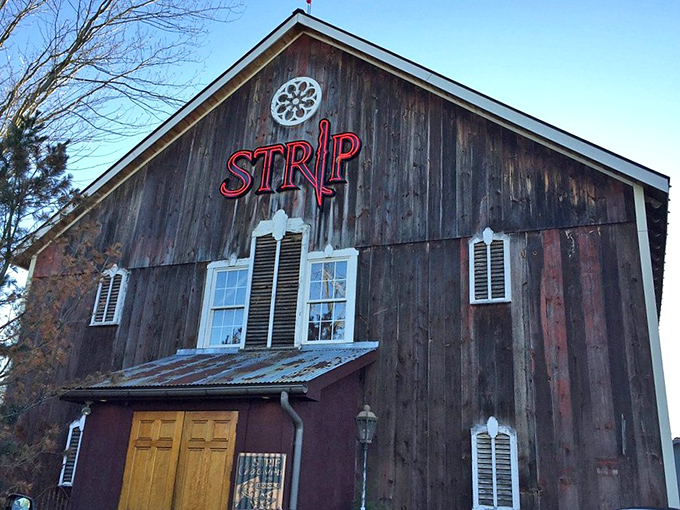That iconic red neon sign against weathered wood is like a lighthouse for hungry travelers&mdash;guiding you to a harbor of exceptional steaks.