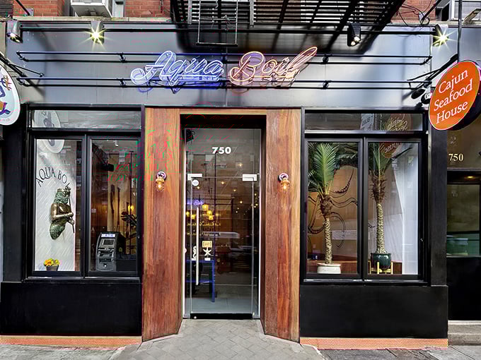 The neon glow of Aqua Boil's sign cuts through Hell's Kitchen's bustle like a lighthouse for hungry seafood lovers seeking their next maritime adventure.