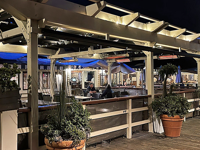 Sunset dining on the deck&mdash;where ocean breezes enhance every bite. The pergola-covered patio creates the perfect California evening atmosphere for seafood indulgence.