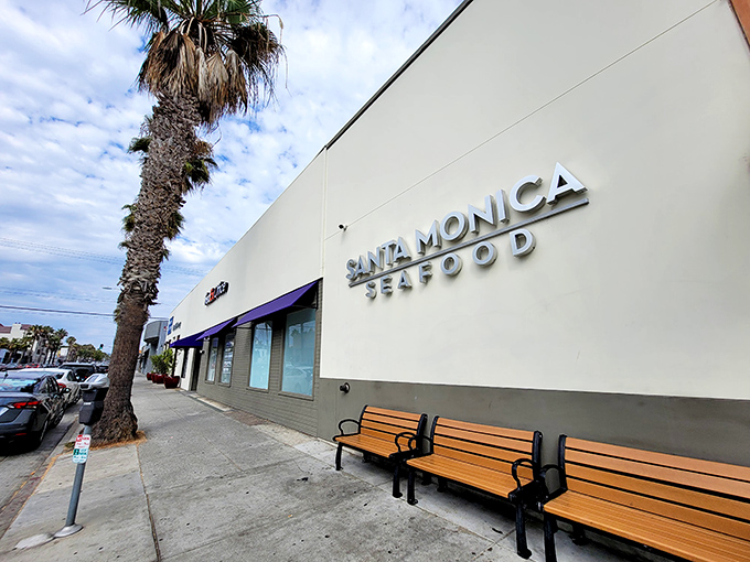 The unassuming exterior of Santa Monica Seafood stands like a culinary lighthouse, beckoning seafood lovers with its simple white walls and iconic blue awnings.