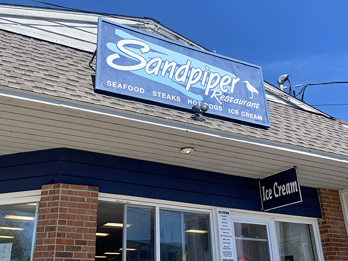 The iconic blue Sandpiper sign beckons seafood lovers like a lighthouse guiding hungry sailors home to East Haven's shore.