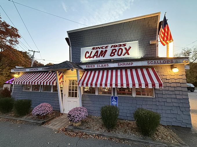 Bathed in golden evening light, the Clam Box's distinctive silhouette and red-striped awnings beckon seafood pilgrims like a lighthouse guiding hungry sailors home.