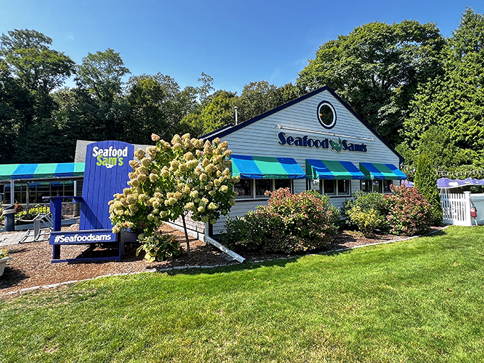 The blue-and-green striped awnings of Seafood Sam's welcome you like a maritime flag signaling "Fresh seafood ahead!" Cape Cod charm personified.