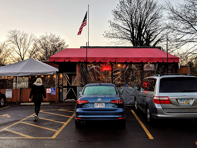 The iconic red awning of DK Diner stands like a beacon at dusk, promising comfort food salvation for the hungry souls of Grandview Heights.