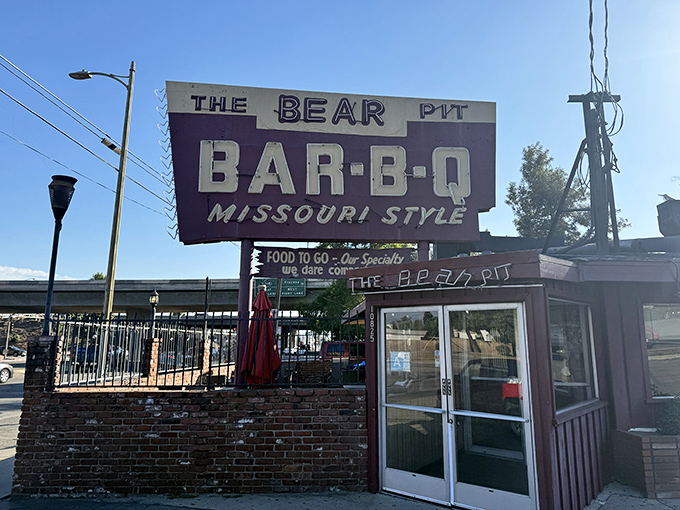 The iconic purple and white sign beckons like a smoky siren call to barbecue pilgrims. Missouri-style meets California sunshine in this unassuming temple of meat.