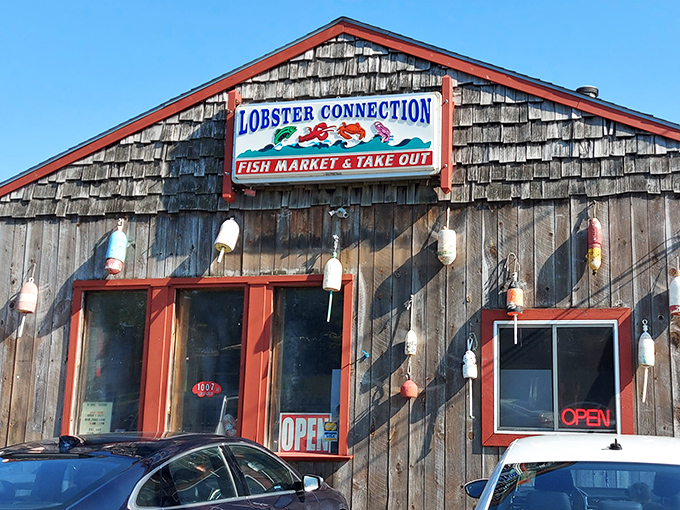 The weathered cedar shakes and colorful buoys aren't just coastal decor &ndash; they're a promise that seafood paradise awaits behind those red-trimmed doors.