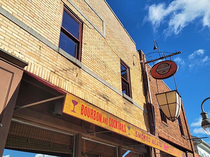 The golden brick facade of Union Woodshop beckons like a barbecue lighthouse on Main Street, promising smoky treasures within. "Bourbon and Cocktails" isn't just signage&mdash;it's a lifestyle statement.